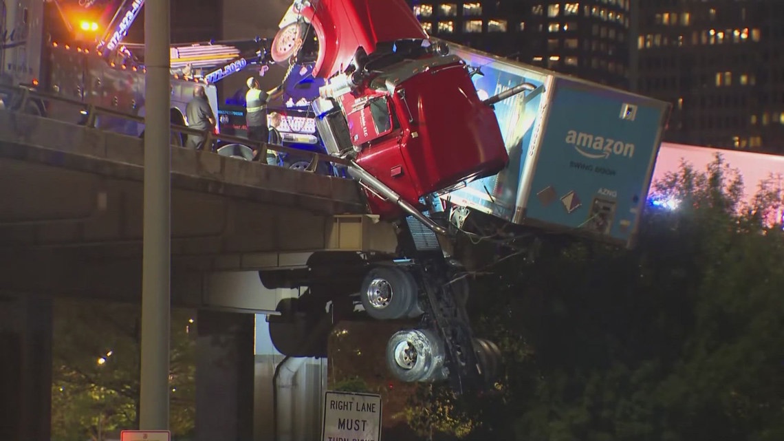 An Amazon 18-wheeler dangles off a bridge in downtown Dallas | wfaa.com