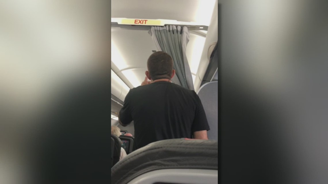 RAW VIDEO: Disruptive passenger handcuffed to wheelchair removed from ...