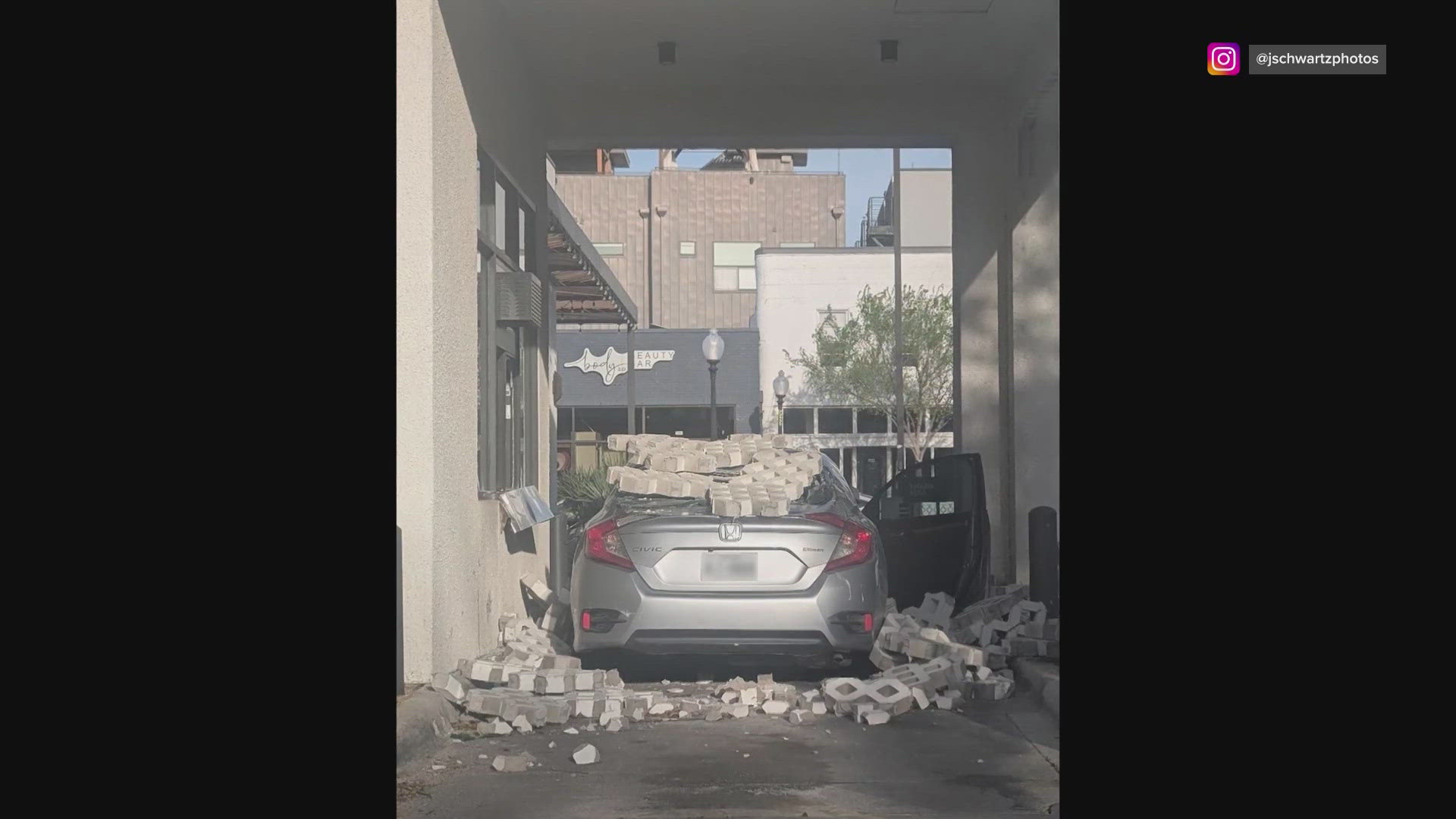 Wind causes a brick wall to fall onto a car in a Starbucks drive-thru ...
