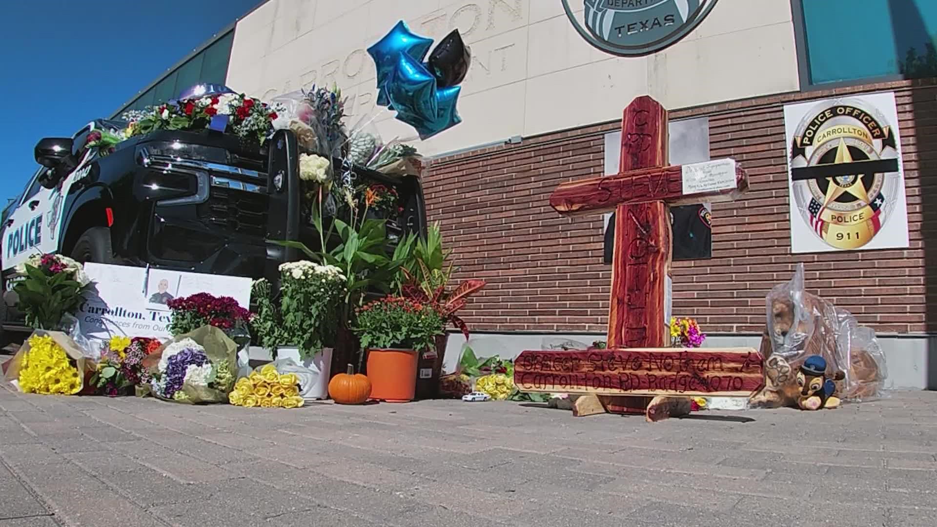 Growing Memorial For Fallen Carrollton Officer Surrounded By Cross