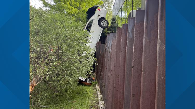 Dallas firefighters rescue driver after car crashes vertically between ...