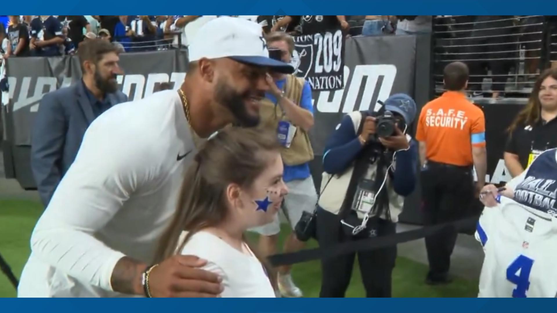 Dak Prescott spends time with a young wheelchair-using fan at a ...