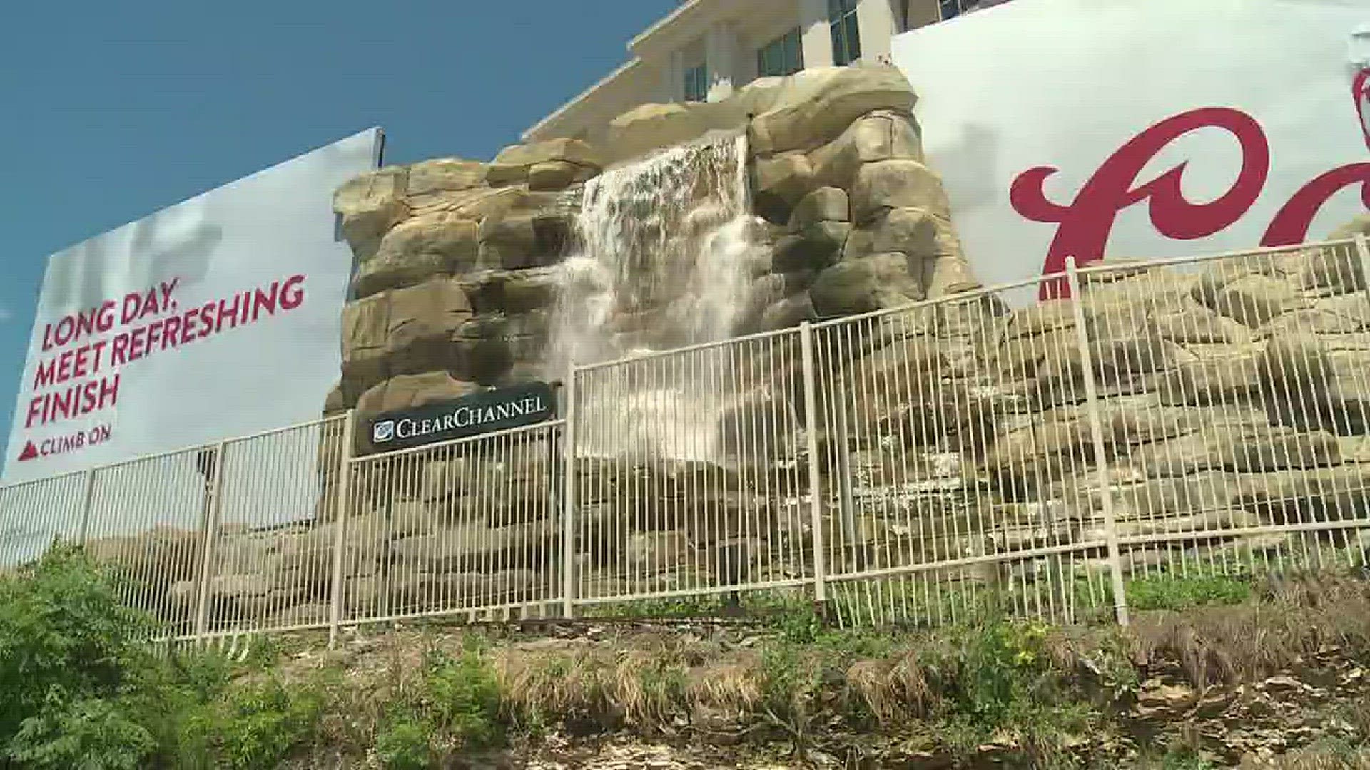 Famous waterfall billboard near downtown Dallas gets artist's makeover ...